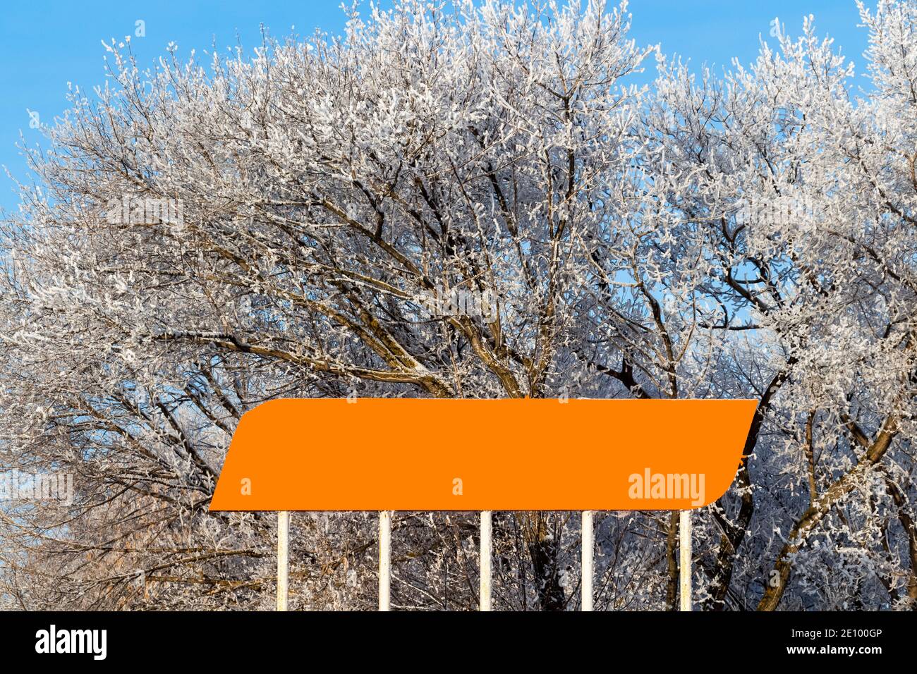 Large orange signboard against the backdrop of snowy trees Stock Photo ...