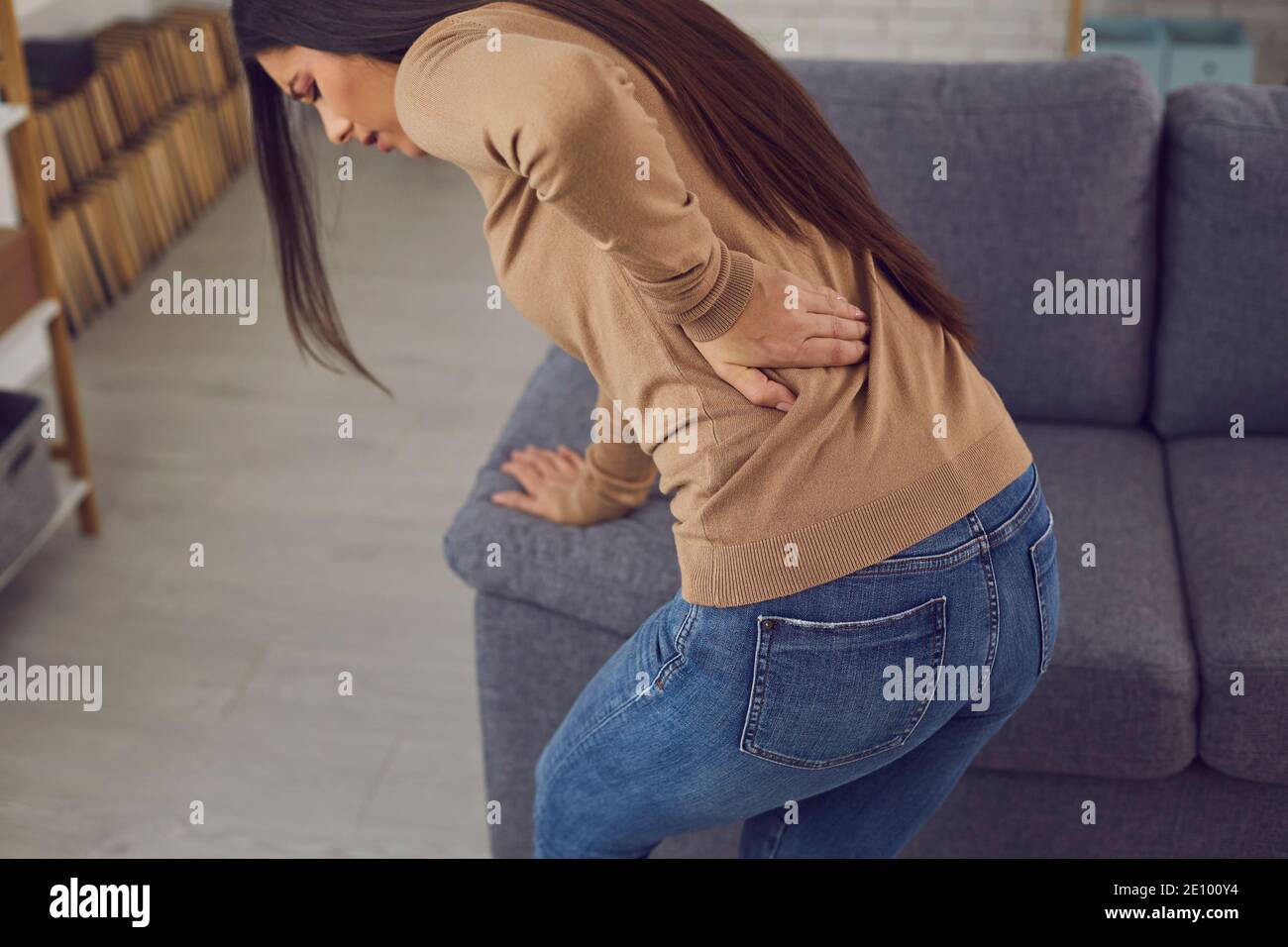 Woman suffering from injury, pinched nerve or rheumatism and touching ...