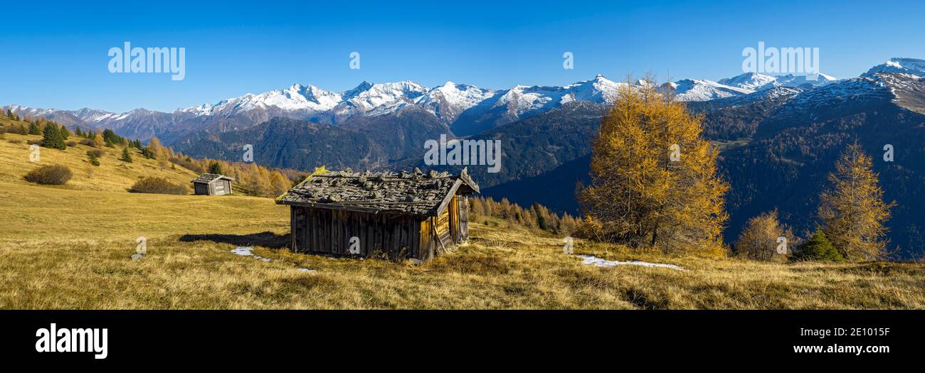 Autumnal mountain landscape with hay barn, behind it the Zillertal Alps ...