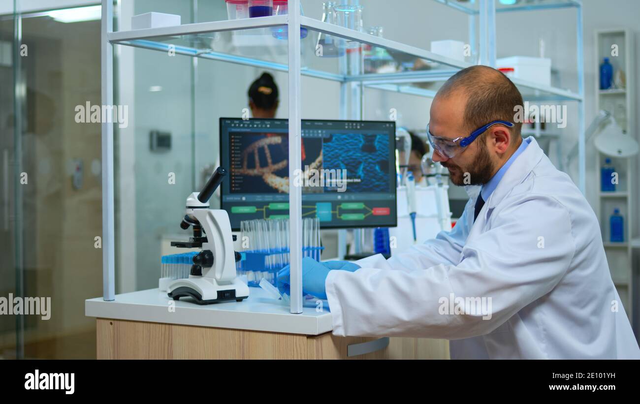 Biologist doctor checking DNA samples in modern equipped laboratory ...