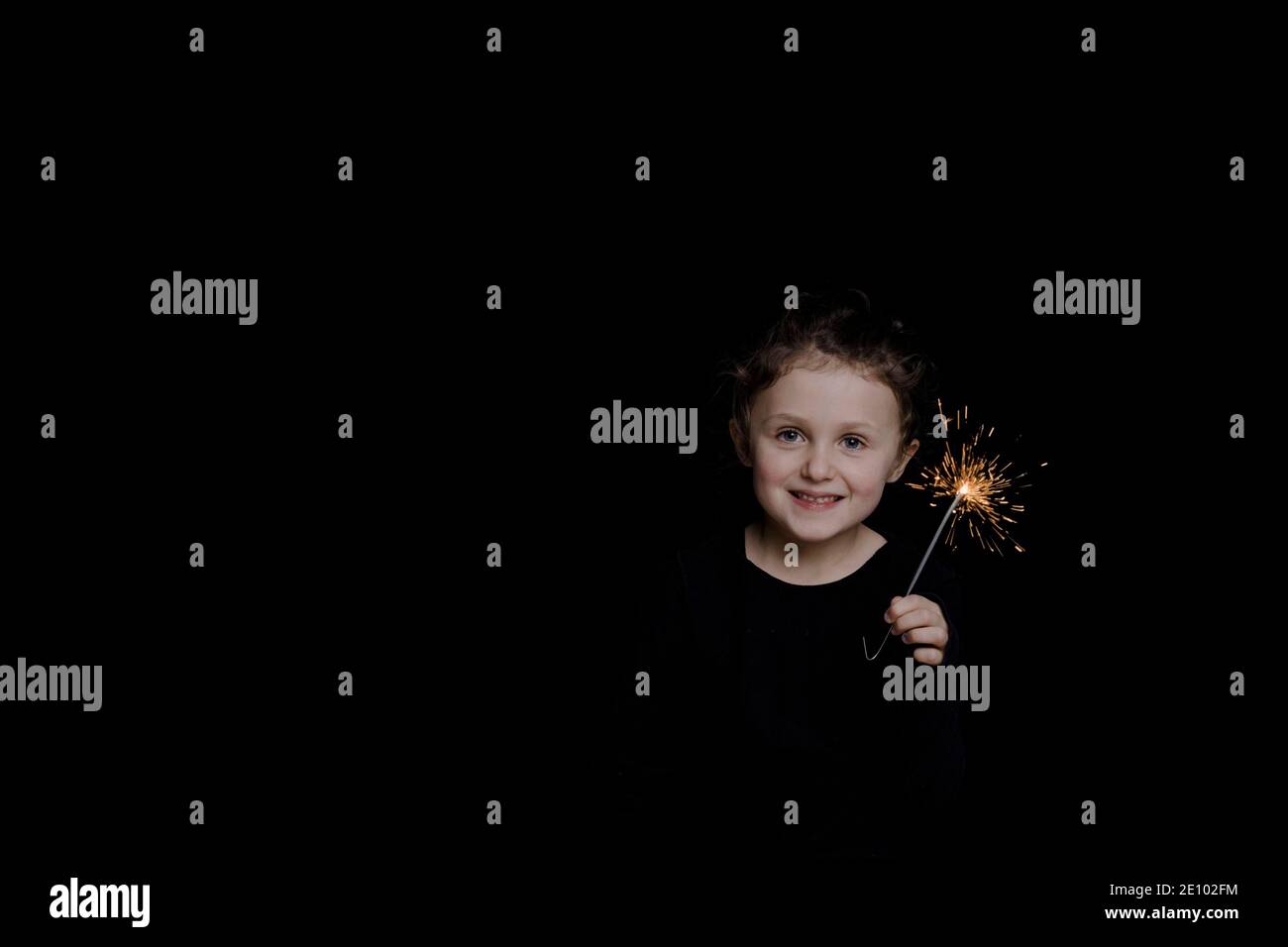 Girl with star thrower in front of dark background, portrait Stock ...