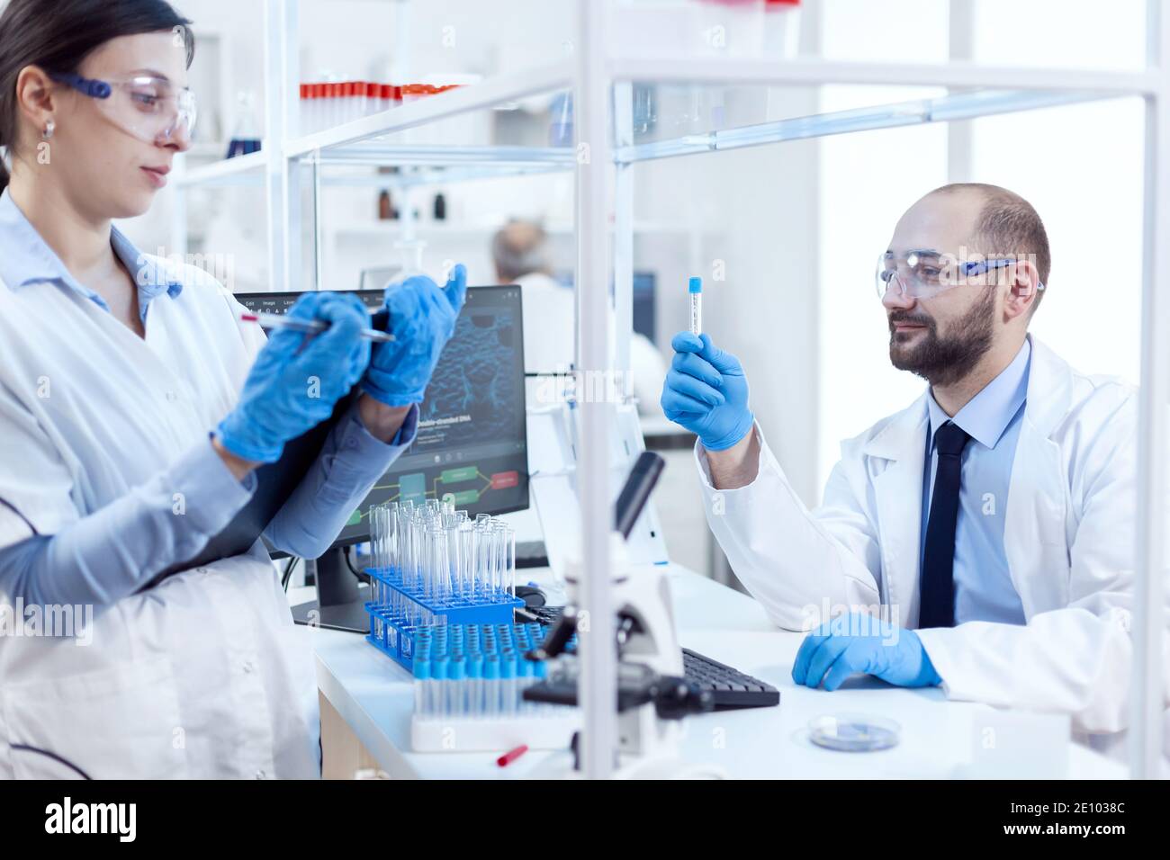 Pharmacology scientist engineering genetic material in busy science lab ...