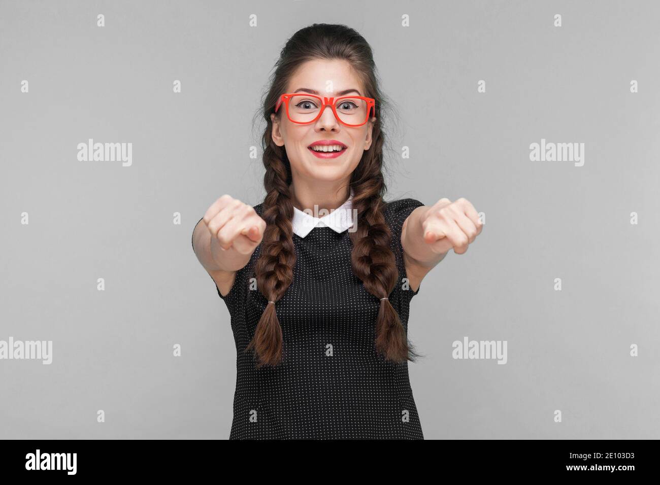 Crazy woman pointing finger at camera and tooth smile. Indoor, studio ...