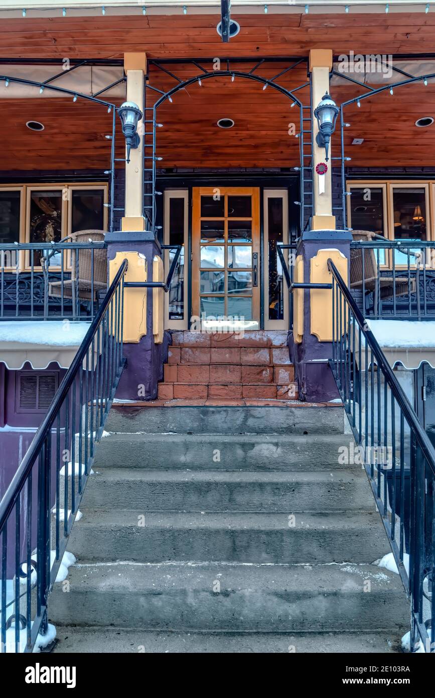 Entrance of building with french door and windows that reflect snow in ...
