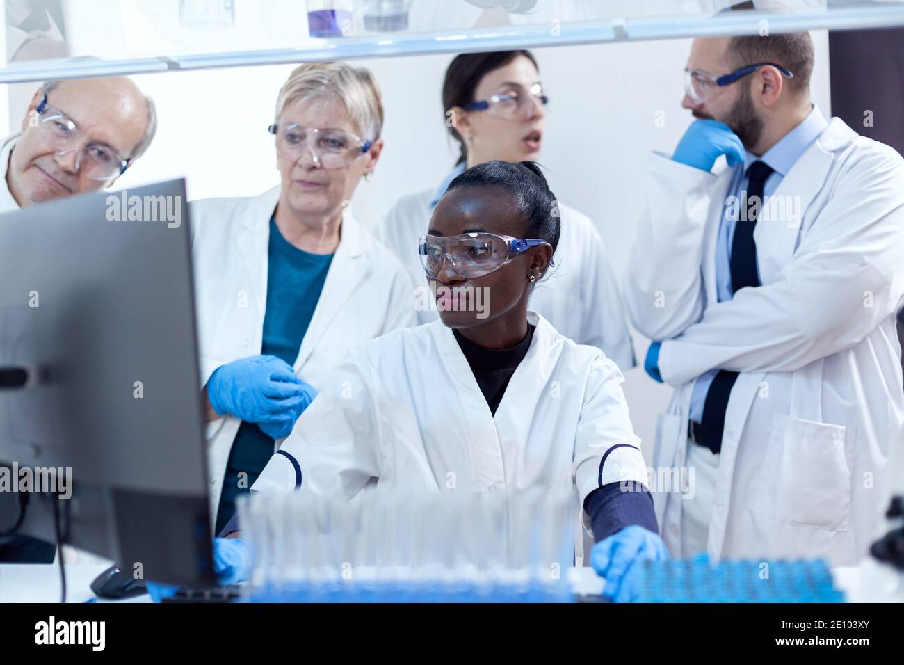 Team of scientists with multiethnicity discussing chemical formula in ...