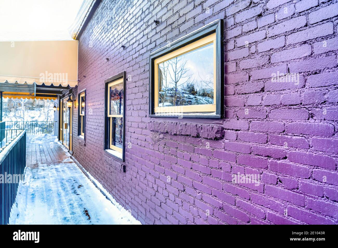 Building exterior with awning over the snowy wooden deck at the ...