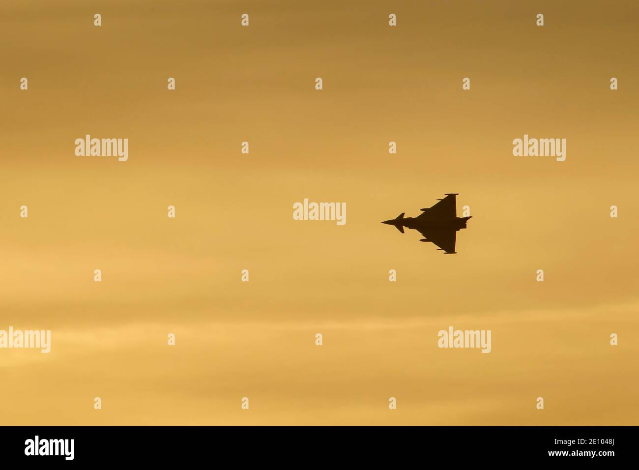 Eurofighter Typhoon aircraft in flight of the Royal air force at sunset ...