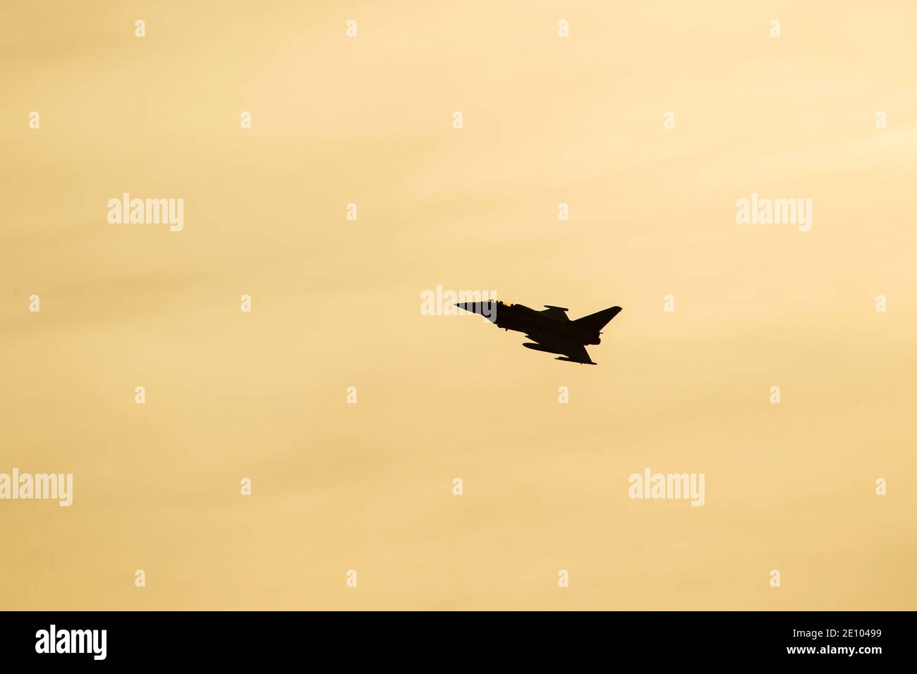 Eurofighter Typhoon aircraft in flight of the Royal air force at sunset ...
