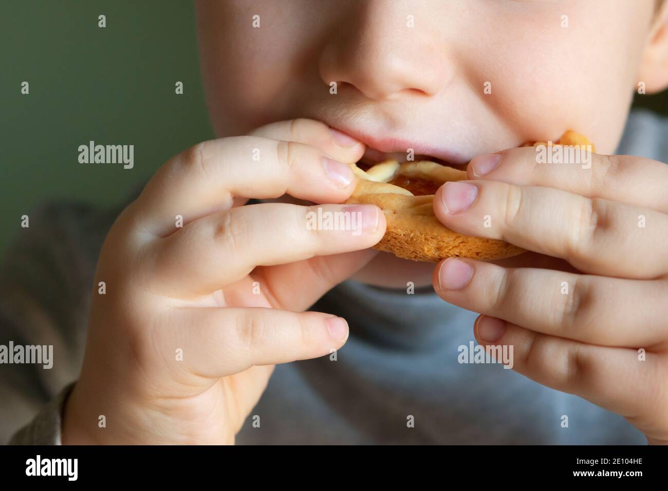 Boy Biting a Snack Stock Photo - Alamy