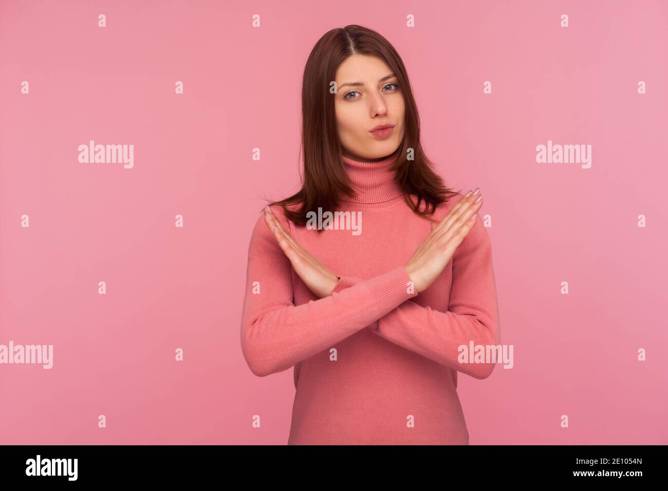 Strict bossy woman with brown hair in pink sweater showing x sign with ...
