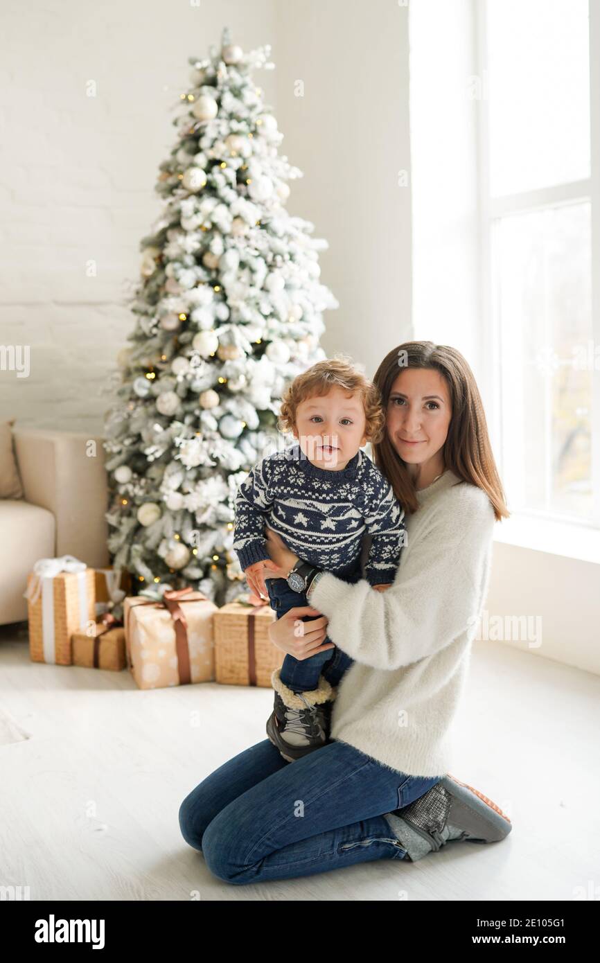 family, winter holidays and people concept - happy mother and baby boy ...