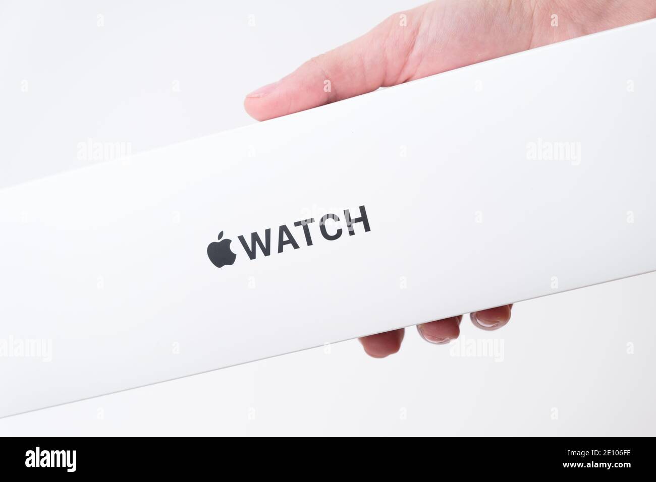 Apple watch box in woman hand on the grey background with copy space ...