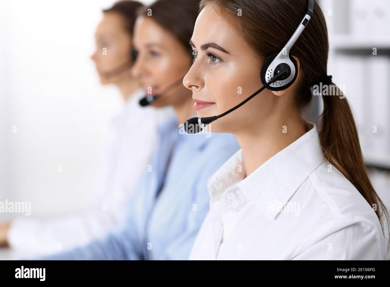 Call center. Group of operators at work. Focus on beautiful business ...