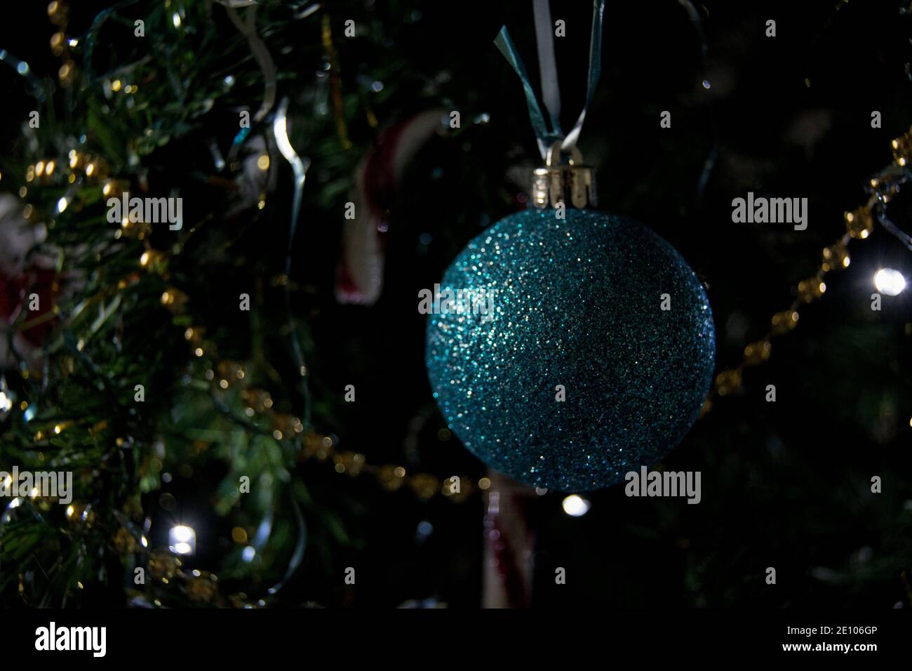 Blue Christmas bauble hanging on a Christmas Tree Stock Photo - Alamy
