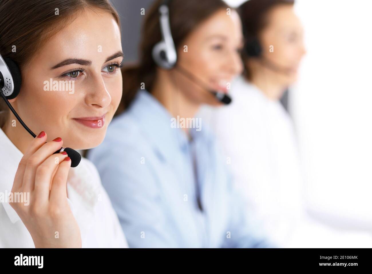 Call center. Group of operators at work. Focus on beautiful business woman in headset Stock ...