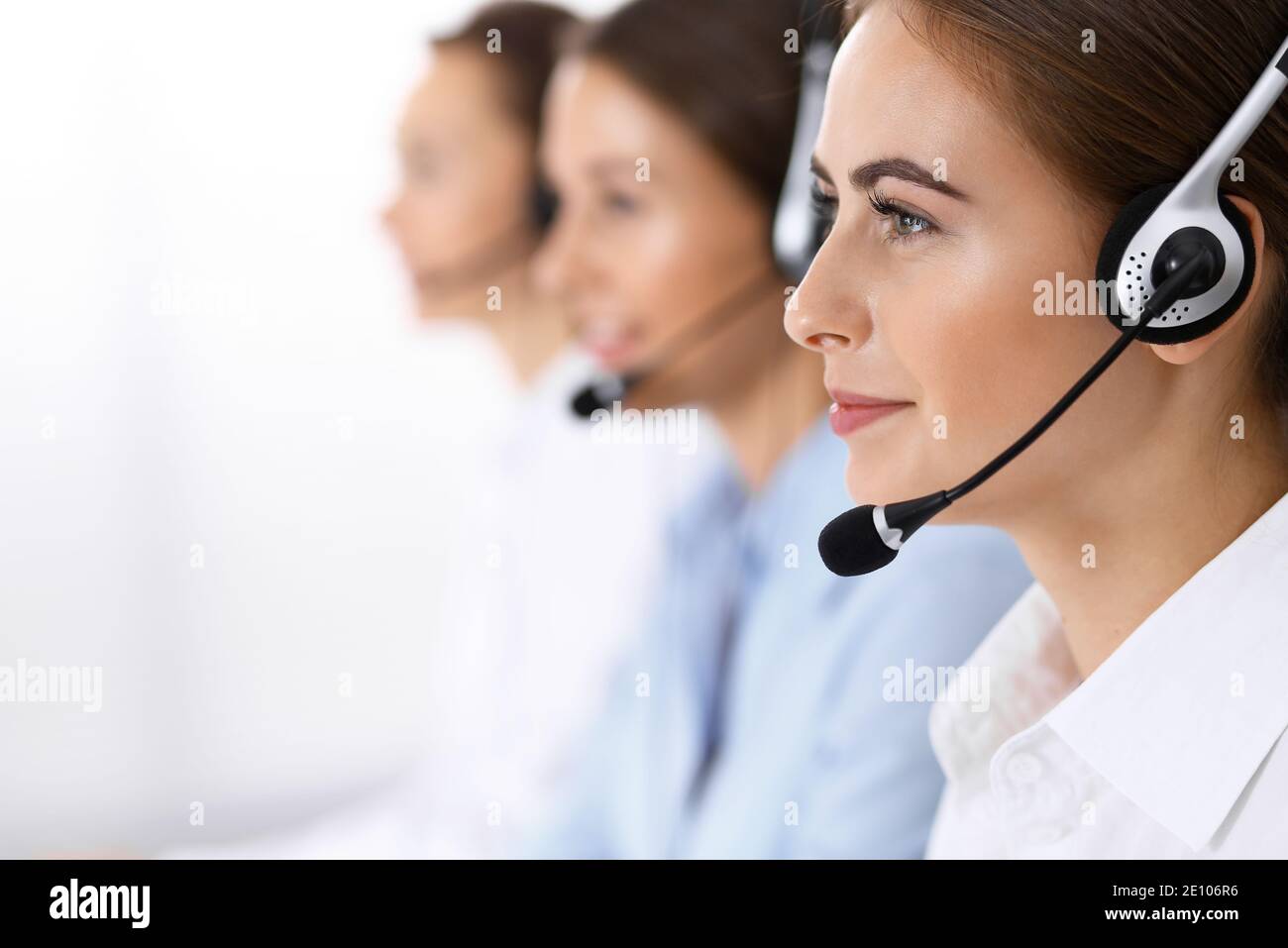 Call center. Group of operators at work. Focus on beautiful business woman in headset Stock ...