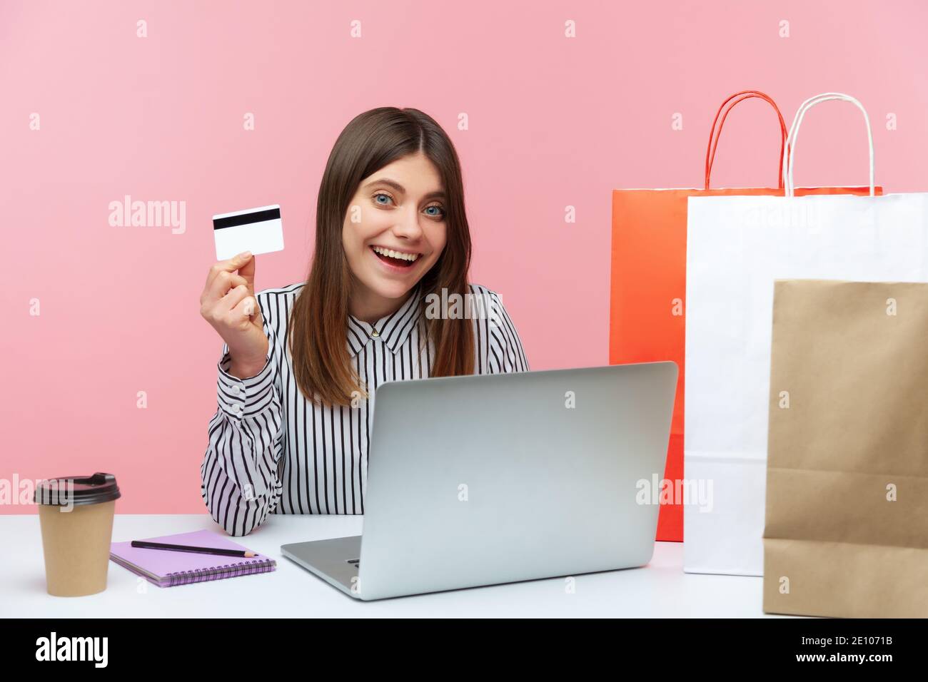 Happy young woman doing payments hi-res stock photography and images ...