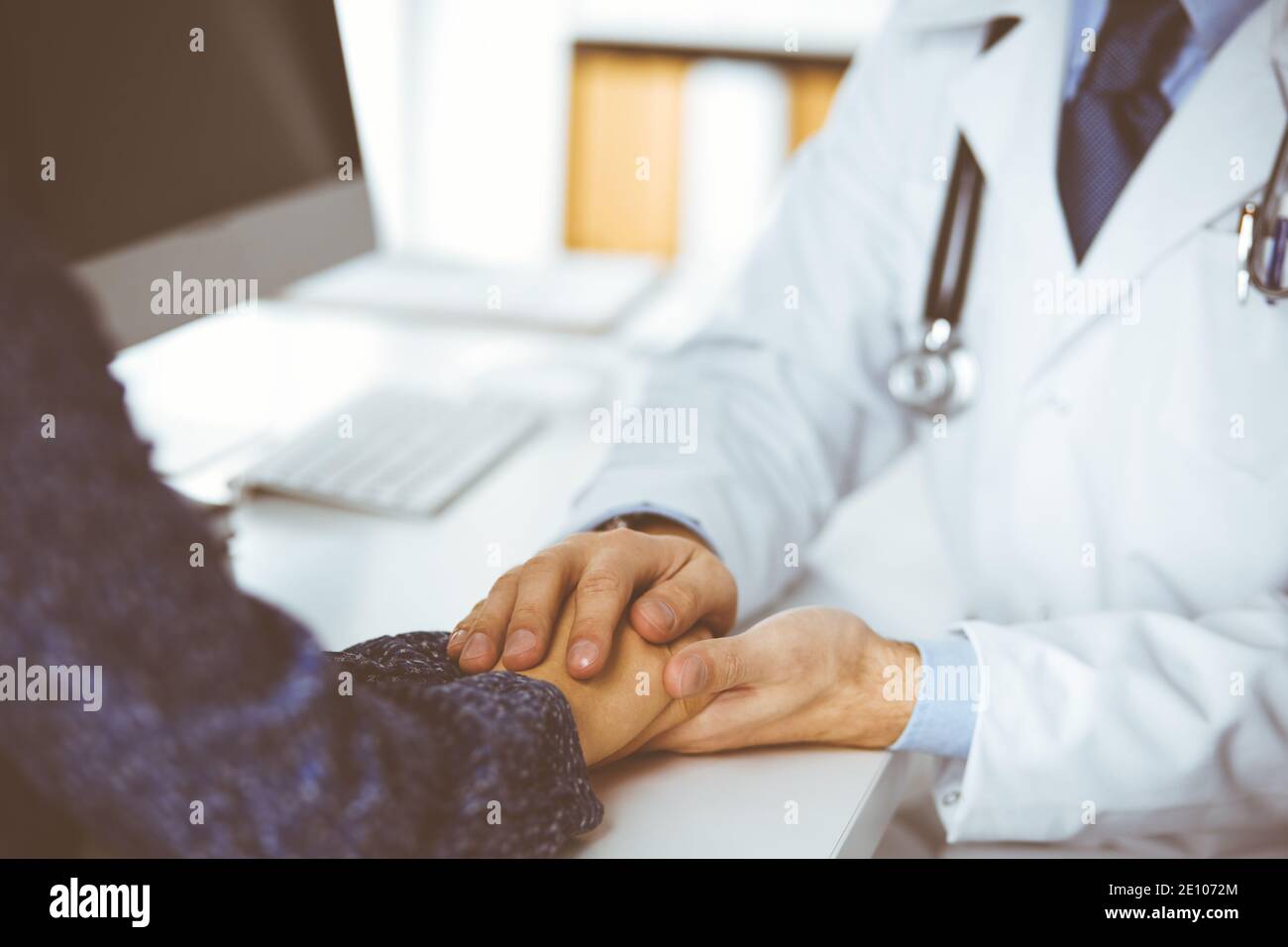 Friendly red-beard doctor reassuring his female patient, close-up ...