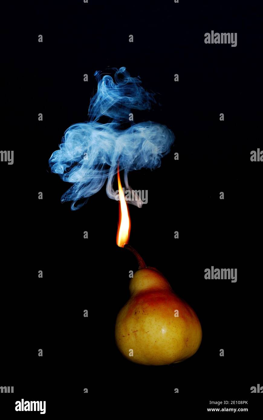 pear portrait with a flame and gray smoke on black background Stock ...