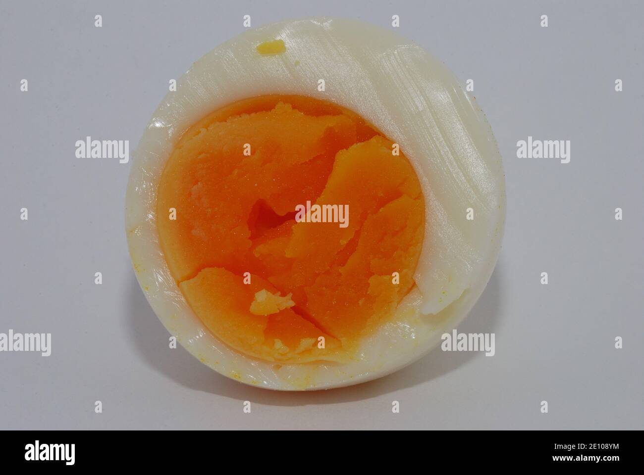 egg with orange yolk on white background closeup Stock Photo - Alamy