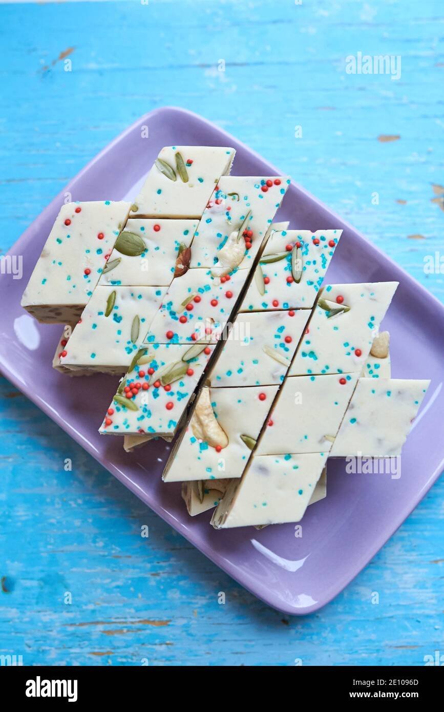 Samarkand halva cut into rhombuses with pistachios and cashews and blue ...