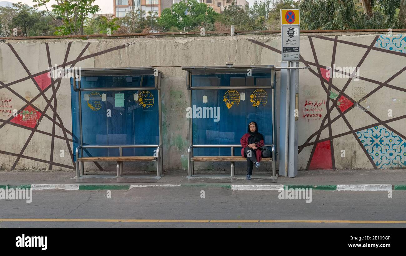 Tehran, Iran - April 2019: Iranian muslim woman waiting for bus at a ...