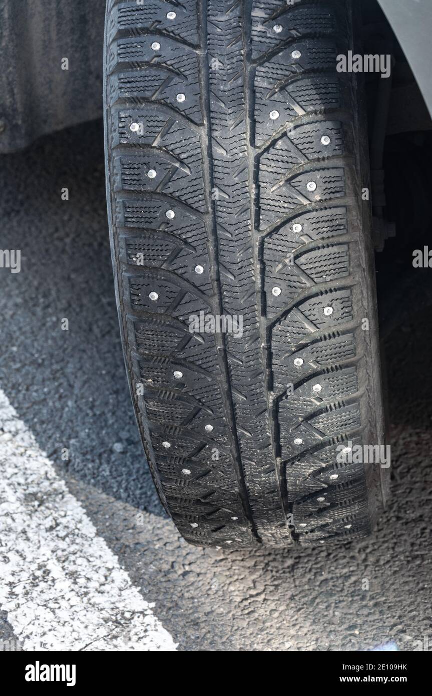 Studded car tire. Car tire with spikes. Winter tire Stock Photo - Alamy