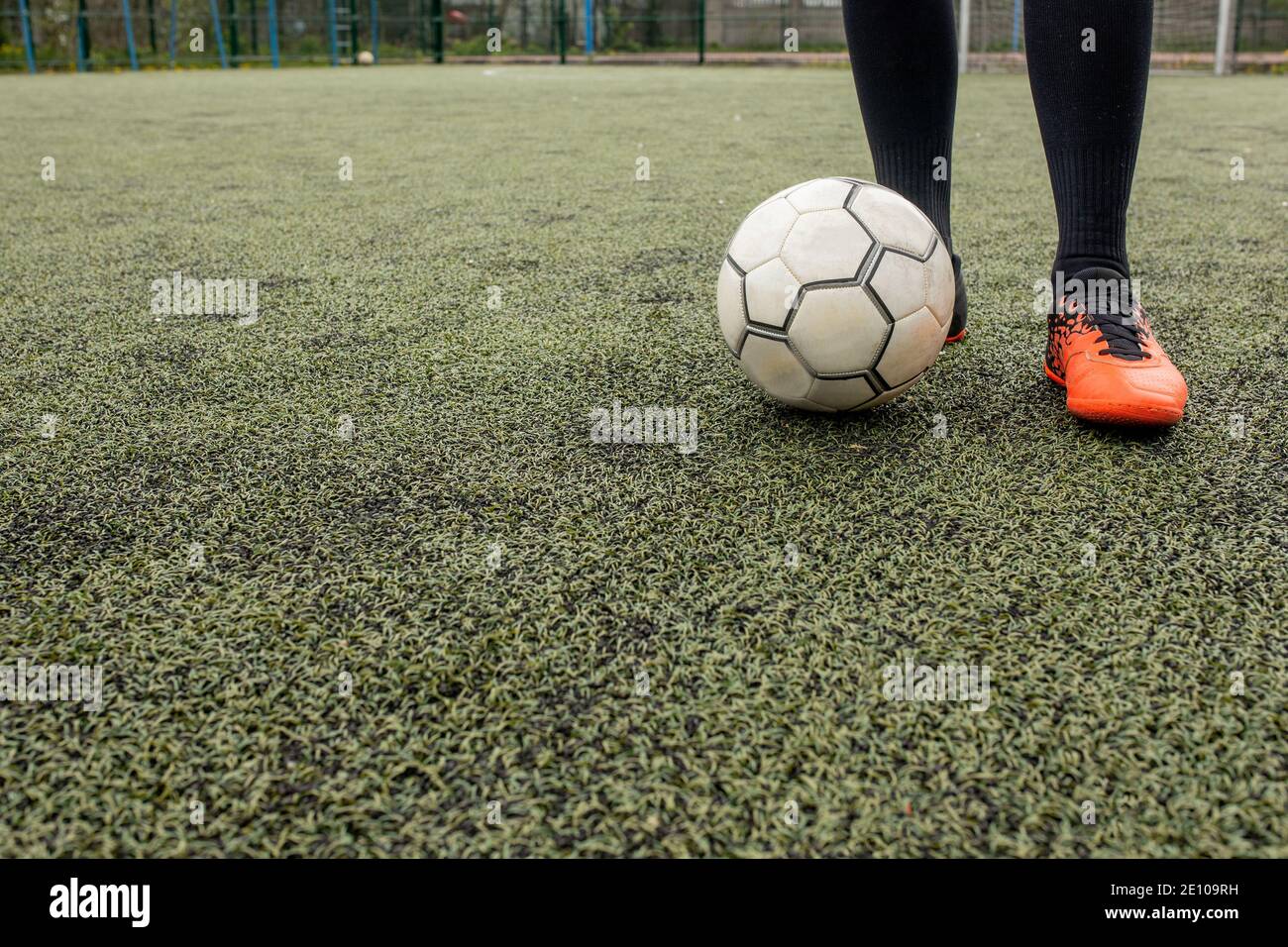 soccer ball with his feet on the football field Stock Photo - Alamy