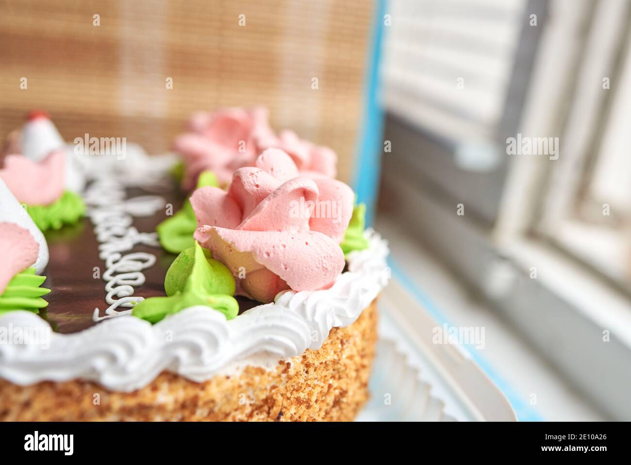 Birthday cake with cream and pink roses. The inscription in Russian ...