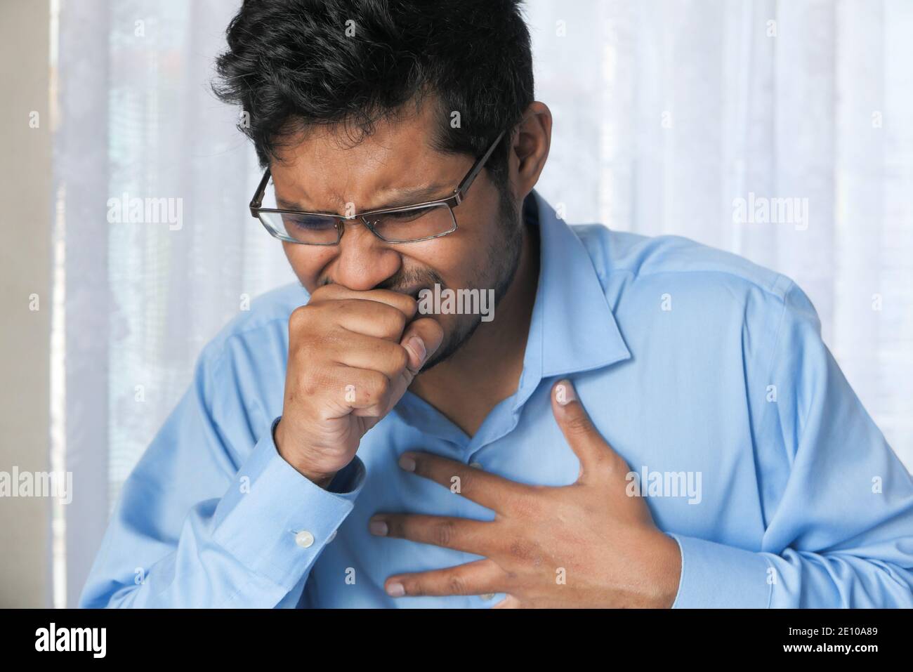 Young sick man coughing sneezes hi-res stock photography and images - Alamy