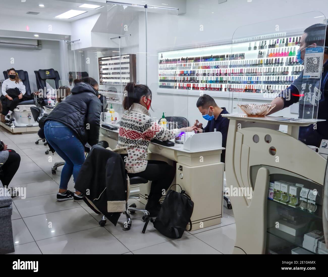 A nail saloon with working staff and customers. This is one of many ...