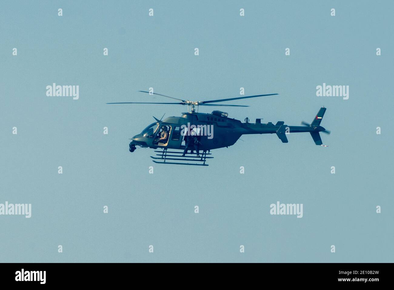 Military chopper in war flies through the sky. Military concept of ...