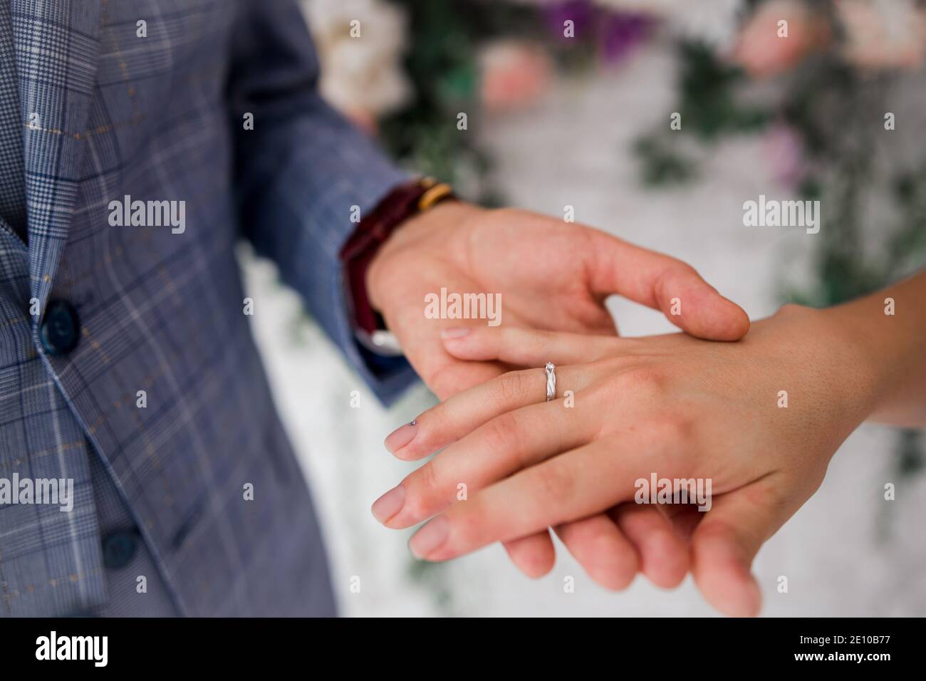 a bride and groom holding hands together Stock Photo - Alamy