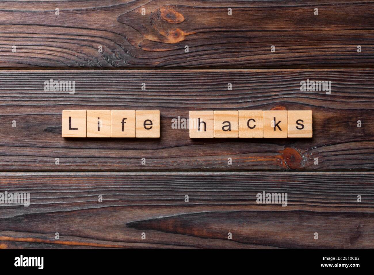 life hacks word written on wood block. life hacks text on table ...
