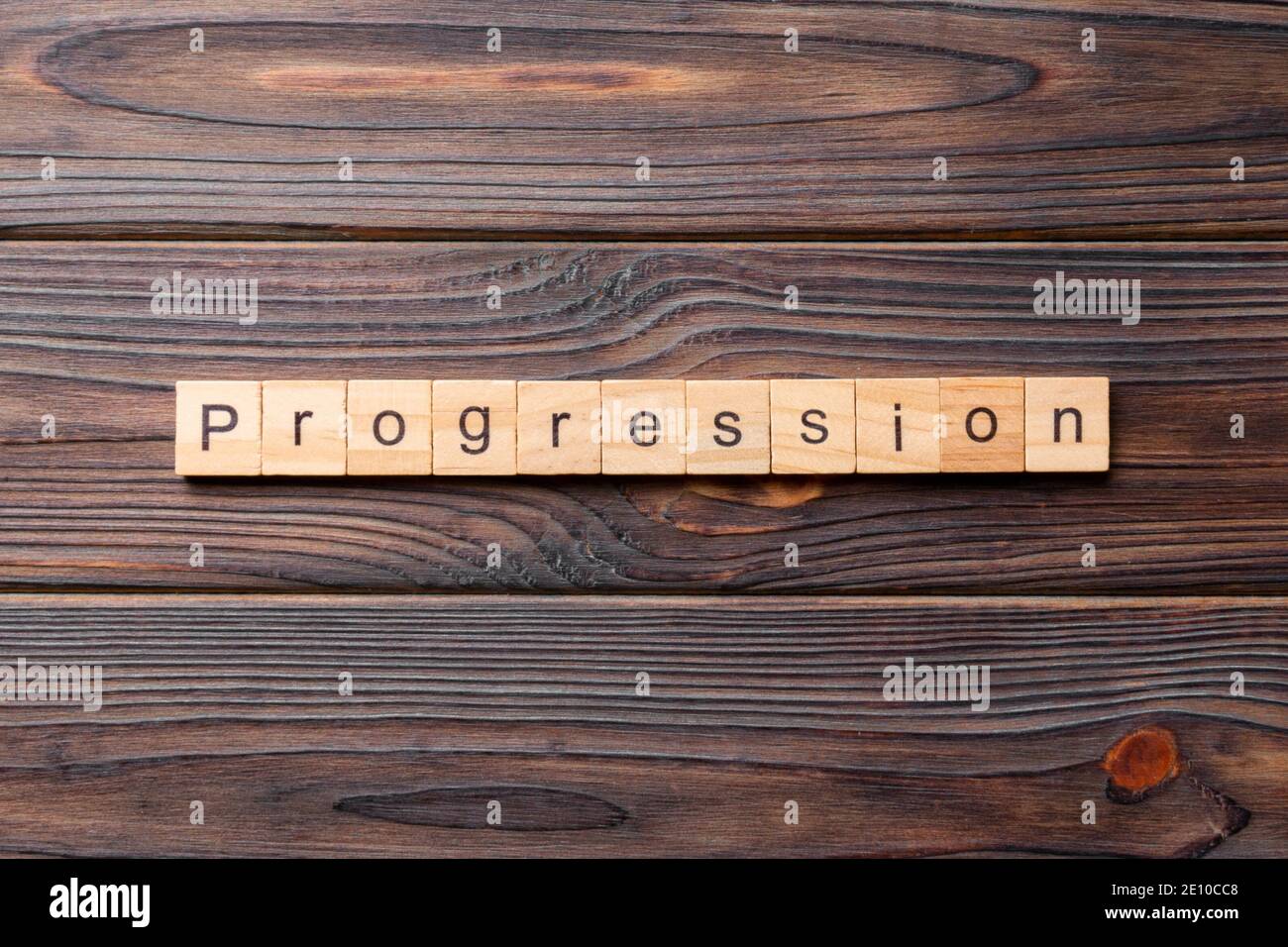 progression word written on wood block. progression text on cement ...