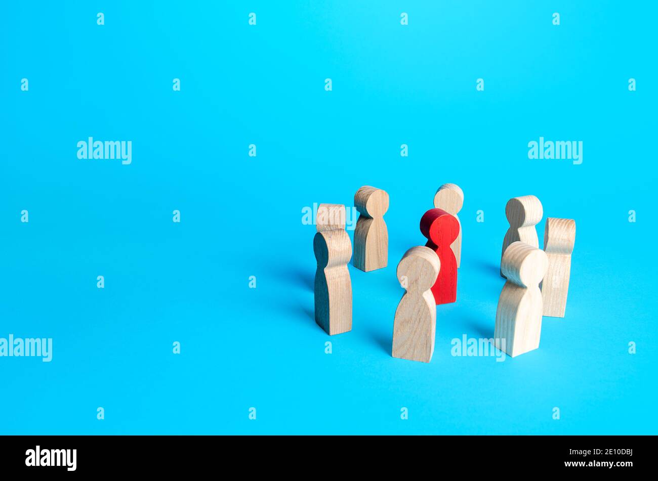 Red figurine of a man surrounded by people. Leader and significant ...