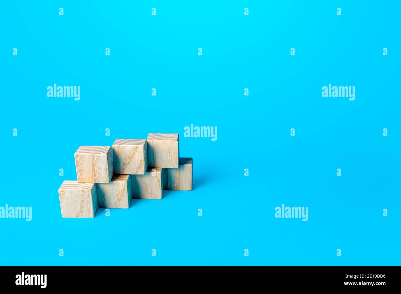 Simple cubic shape assembled from blocks on a blue background ...