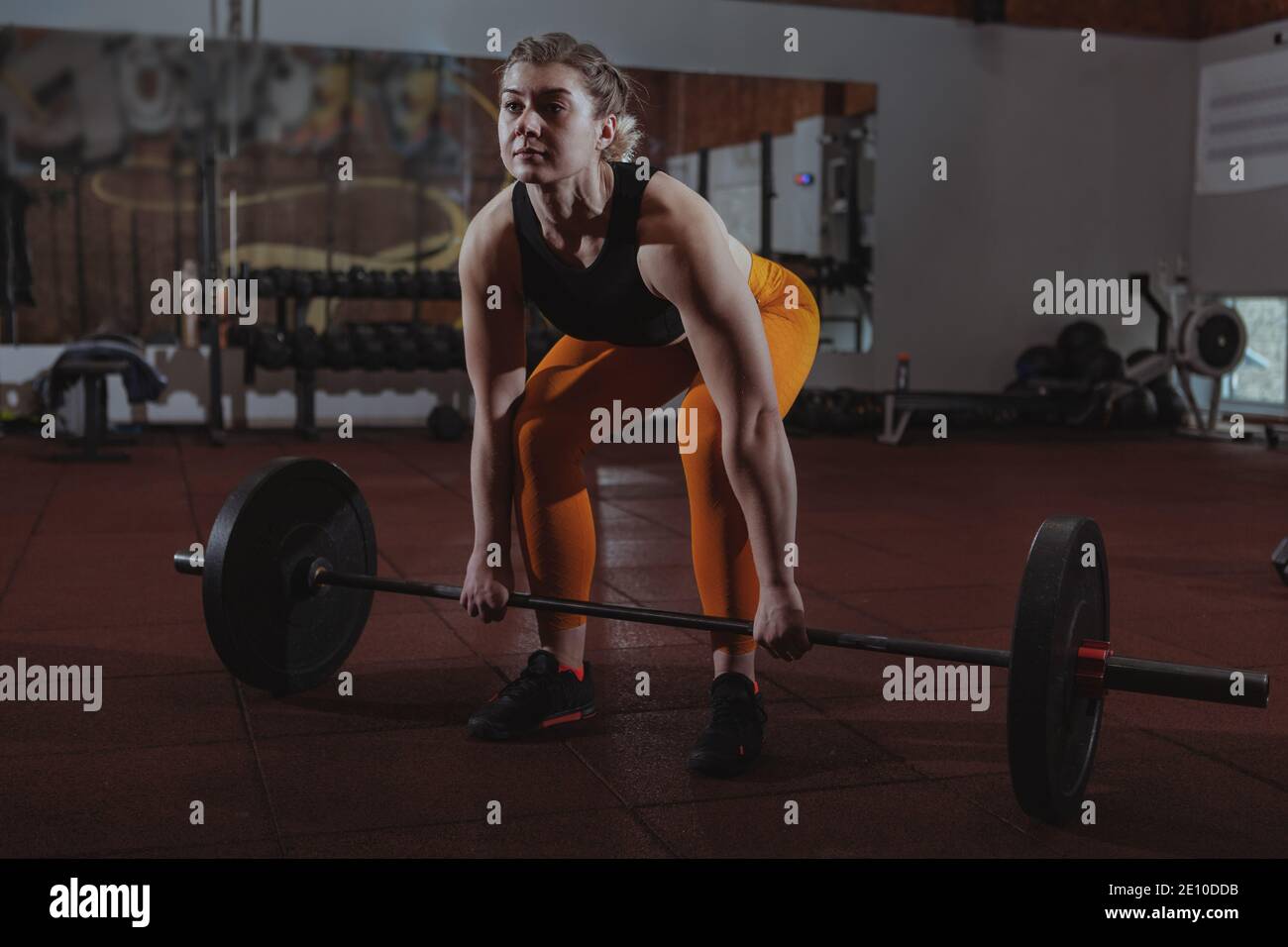 Full length shot of a strong female crossfit athlete working out with ...