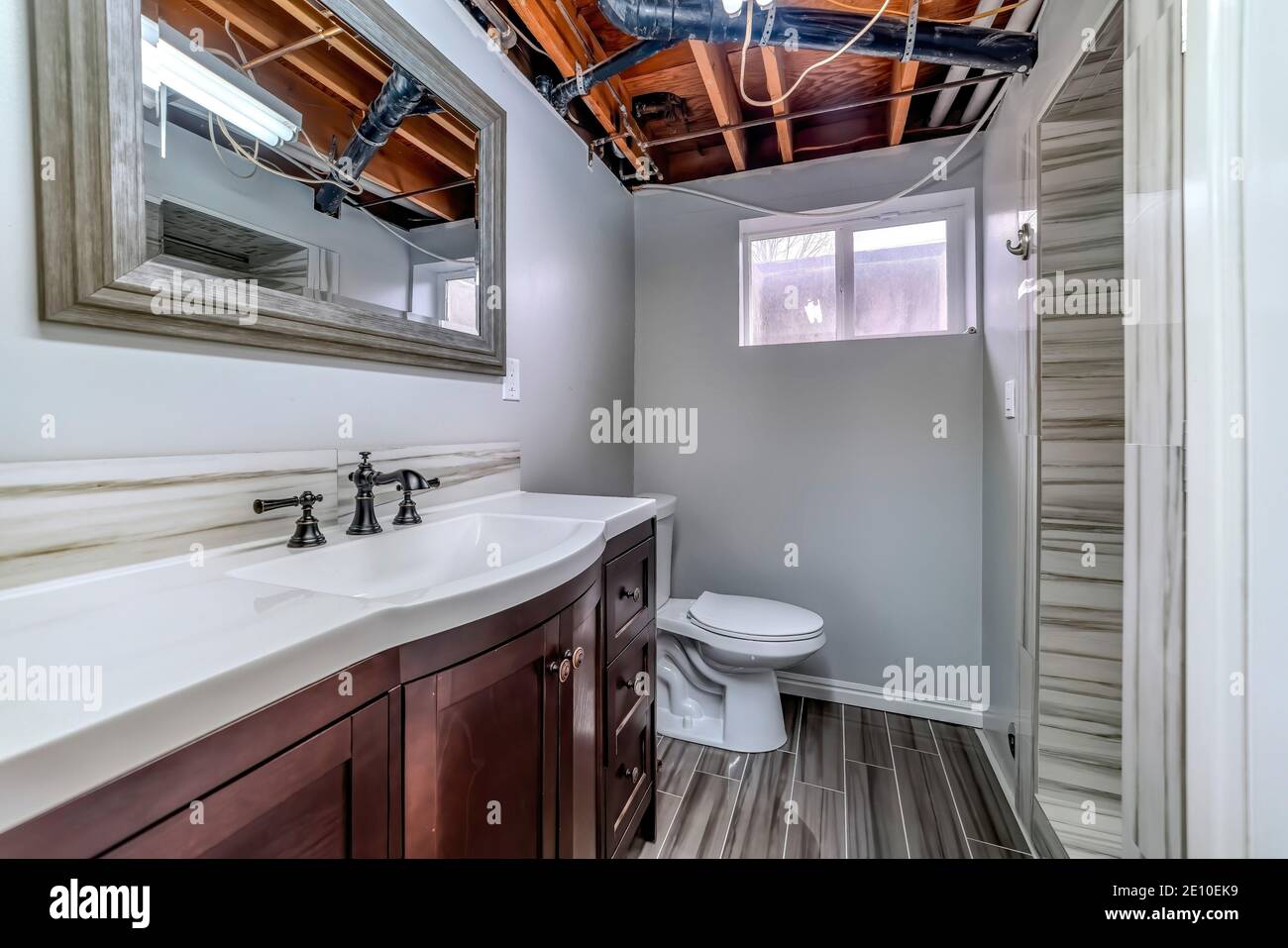 Vanity area and toilet in residential bathroom with ceiling under ...