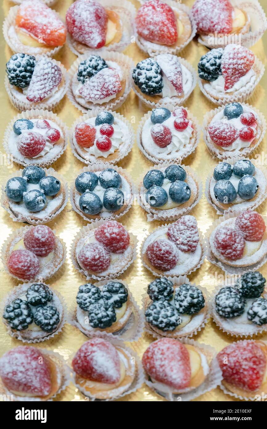 Pastry shop display window with variety of mini desserts and cakes ...