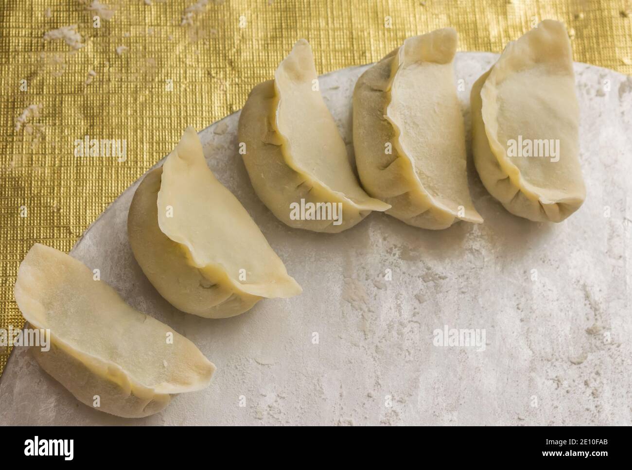 Fresh homemade chinese dumplings on a gold and silver background Stock ...