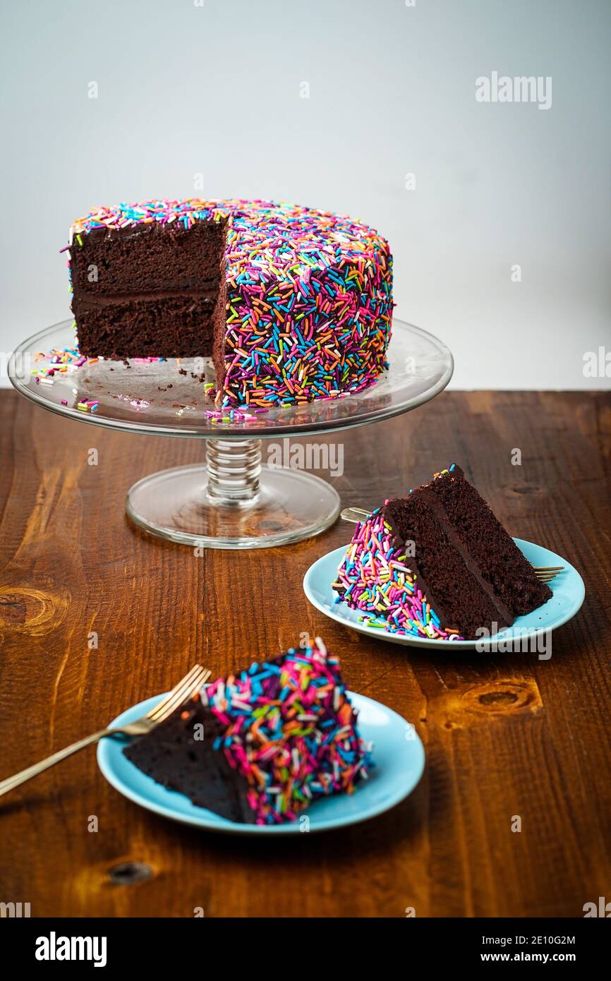 Chocolate cake with colorful sprinkles Stock Photo - Alamy