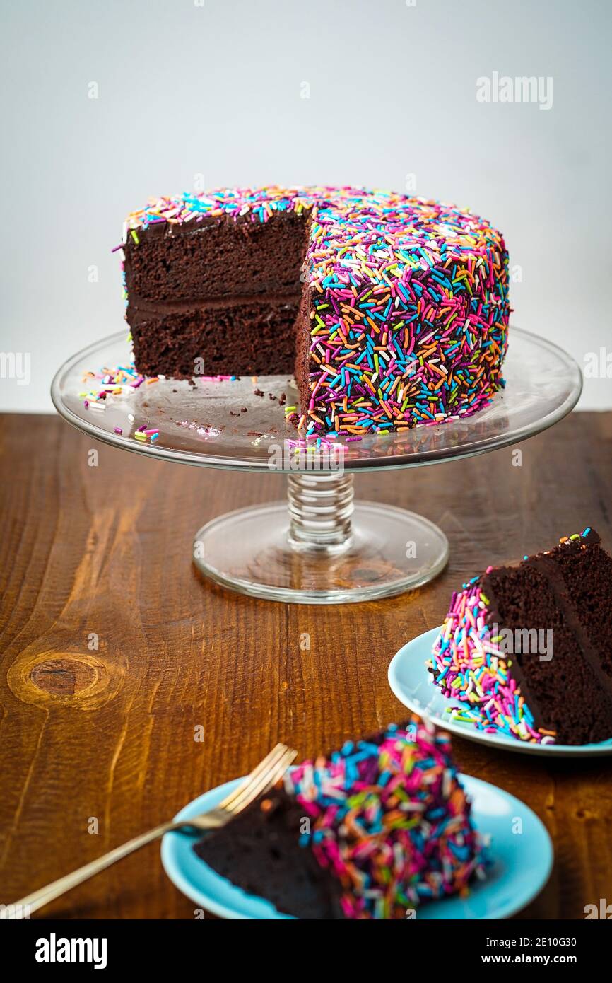 Chocolate cake with colorful sprinkles Stock Photo - Alamy