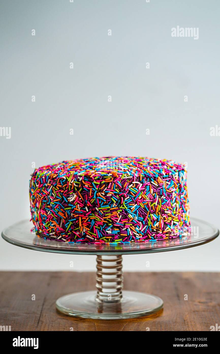 Chocolate cake with colorful sprinkles Stock Photo - Alamy
