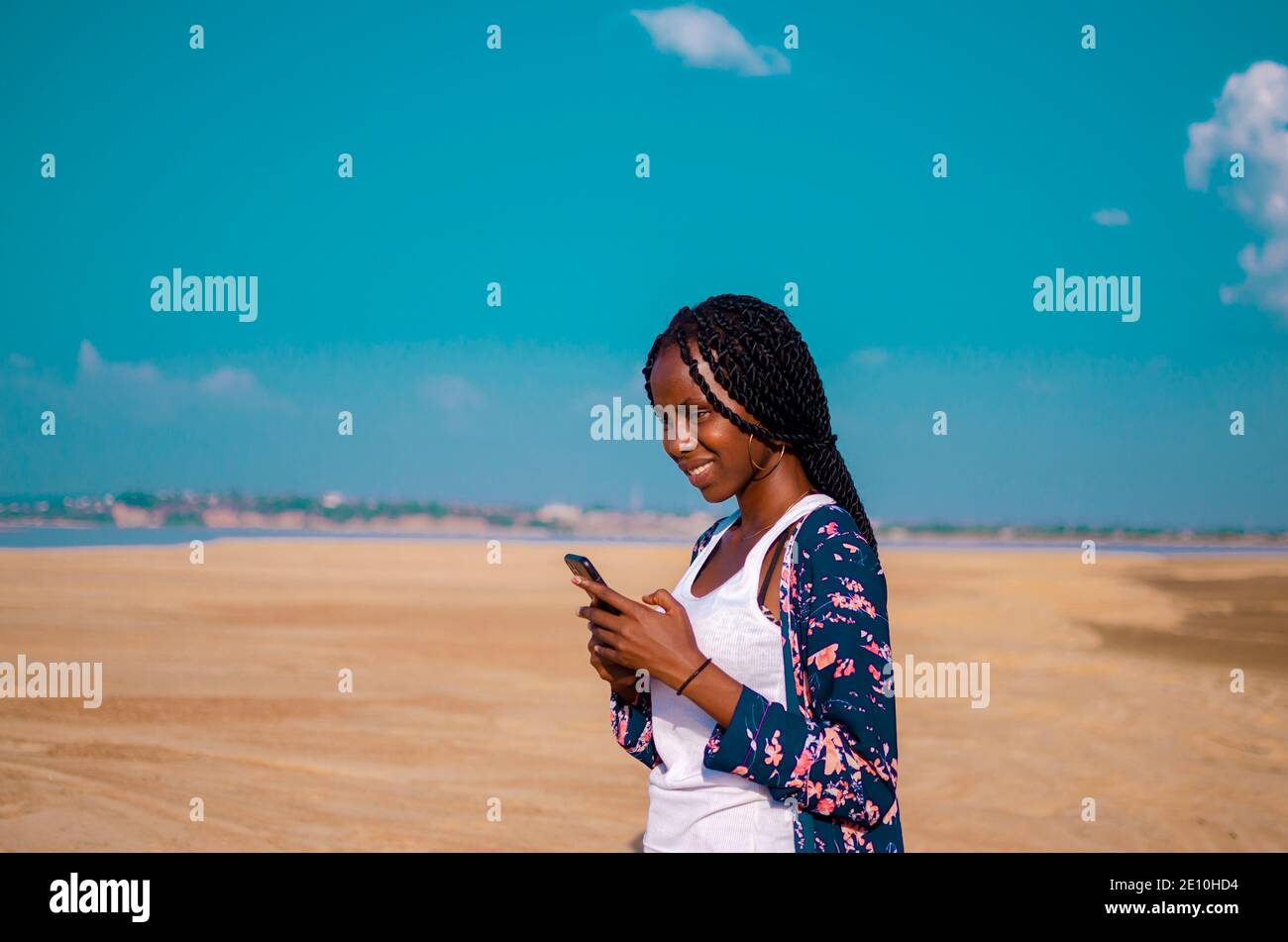 a young pretty african lady addicted to her cellphone got excited Stock ...