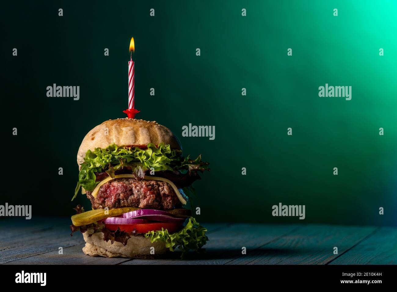 Single Cheeseburger With A Burning Candle Stock Photo - Alamy