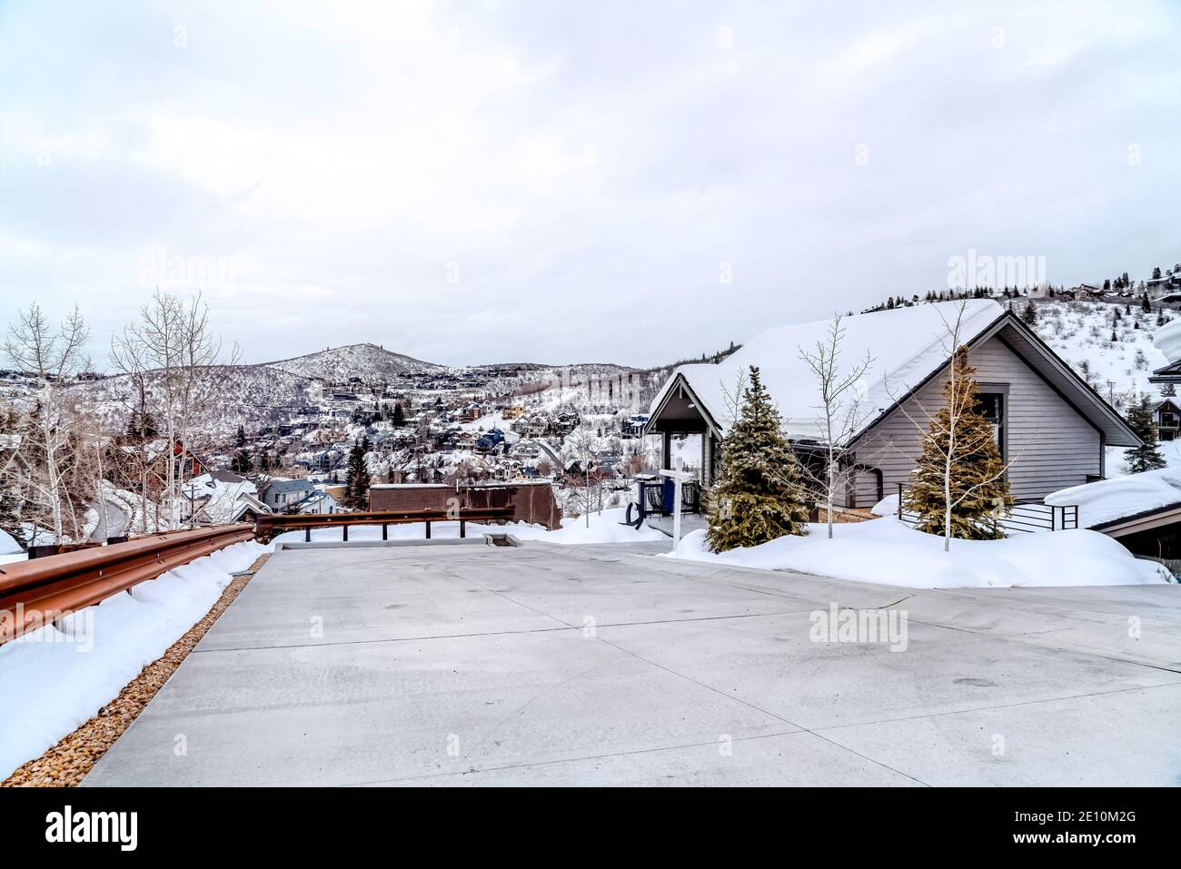 Road at a neighborhood in scenic mountain with views of snowy slopes in ...