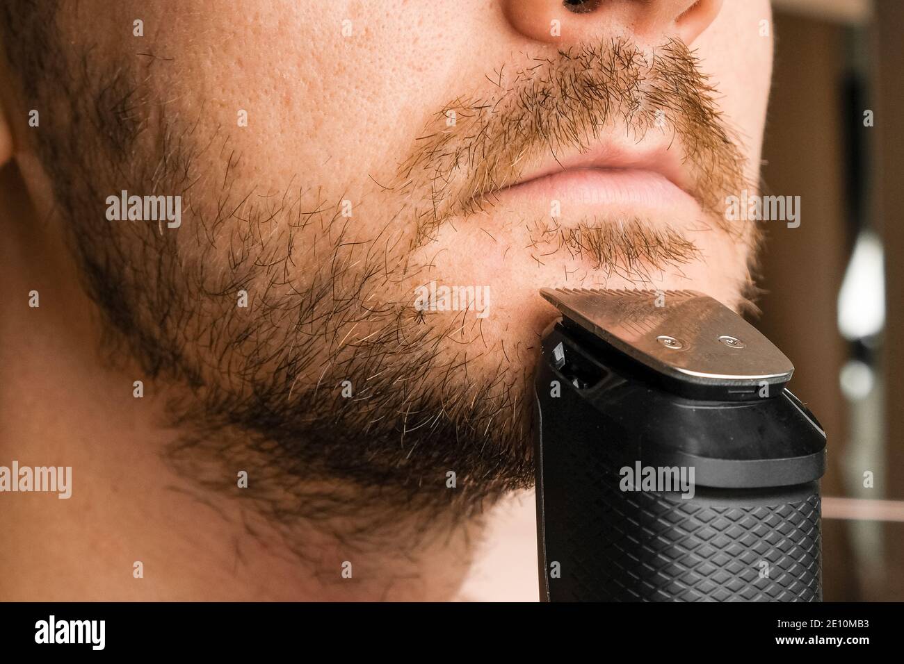 Man shaving his short stubble. Irritation after electric razor shaving ...