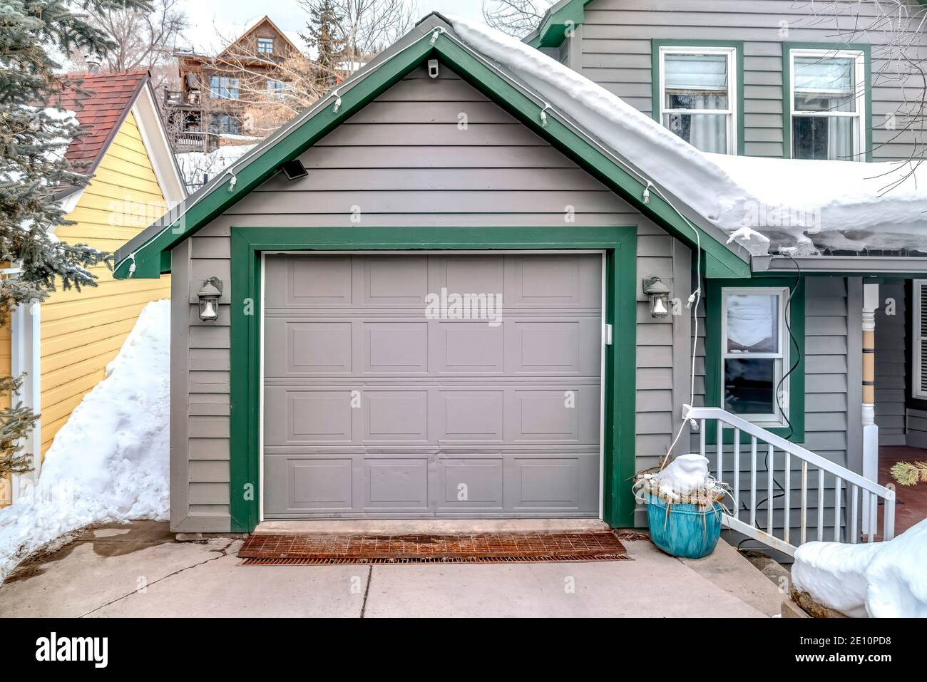 Attached garage of a house with gable roof and gray cladding on ...
