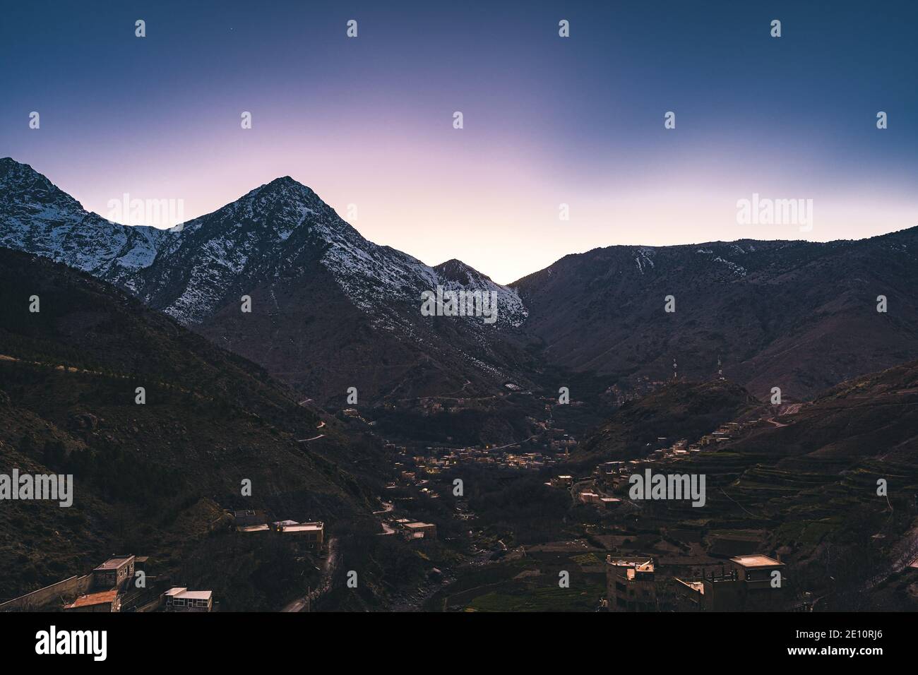 Night sky scene with the Milky Way and stars above Imlil village. Small ...